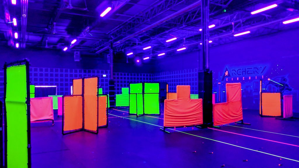 Archery Circuit arena, inside, blacklights on - Archery Circuit